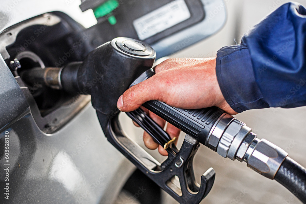 Refueling the car at a gas station fuel pump. Man hand refilling and ...