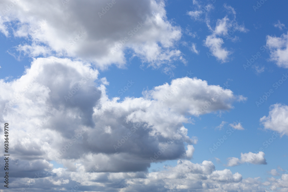 White fluffy clouds on a summer blue sky in cartoon style for ...