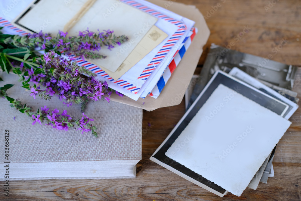 paper book, old photographs, home archive, letter on old wooden table ...