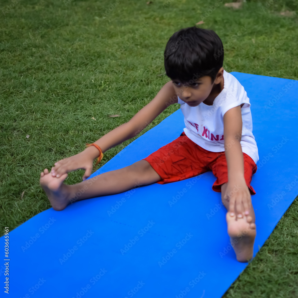 Asian smart kid doing yoga pose in the society park outdoor, Children's ...