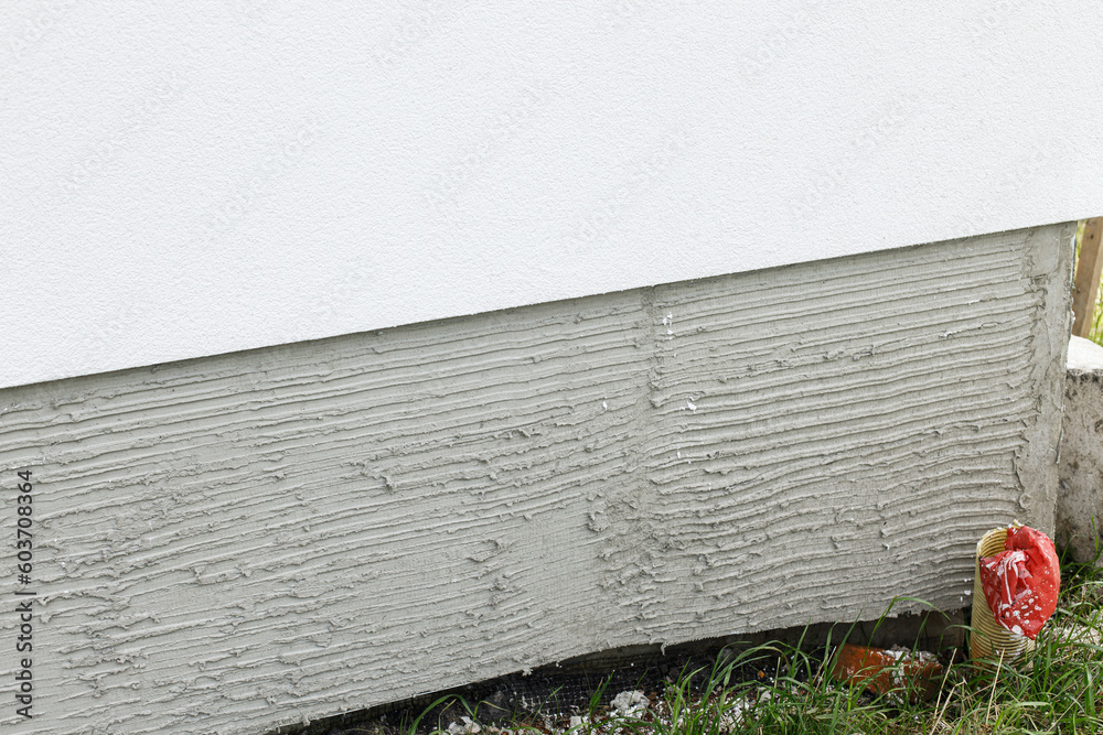 Facade renovation, insulation with mineral wool and white plaster walls ...