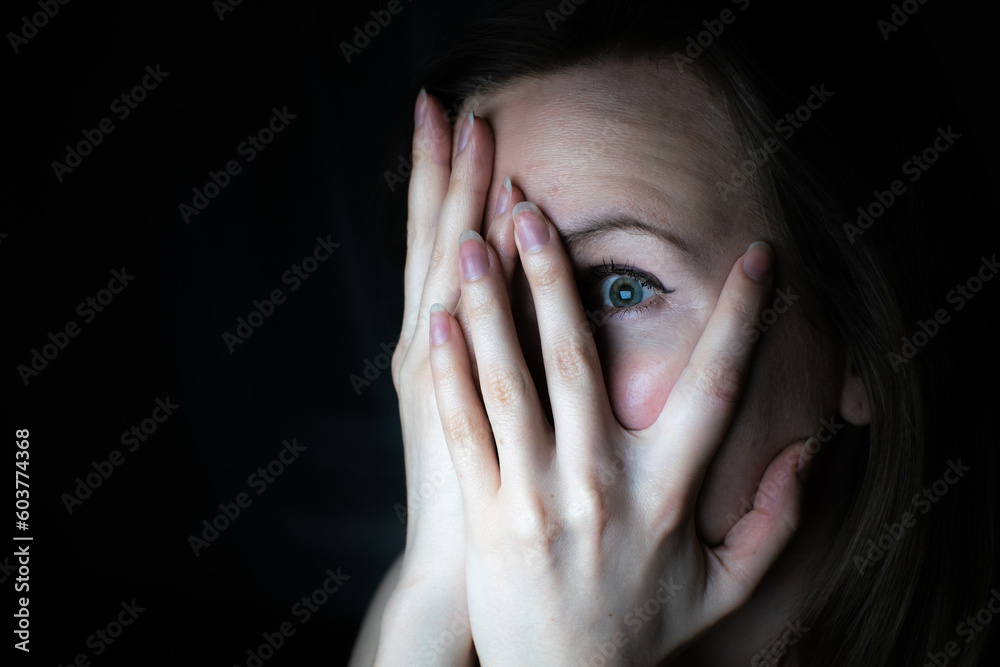 Woman is watching something scary. Close up scared girl face. Stock ...