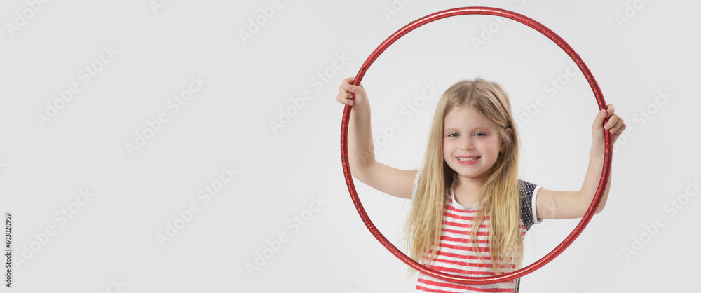 Foto de Studio portrait of beautiful cheerful little girl playing with ...