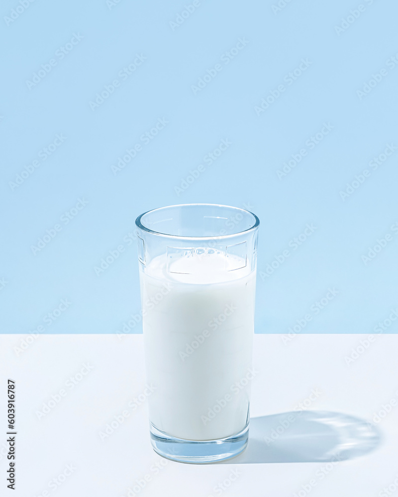 Minimal summer concept of food and drink with glass of milk on pastel ...