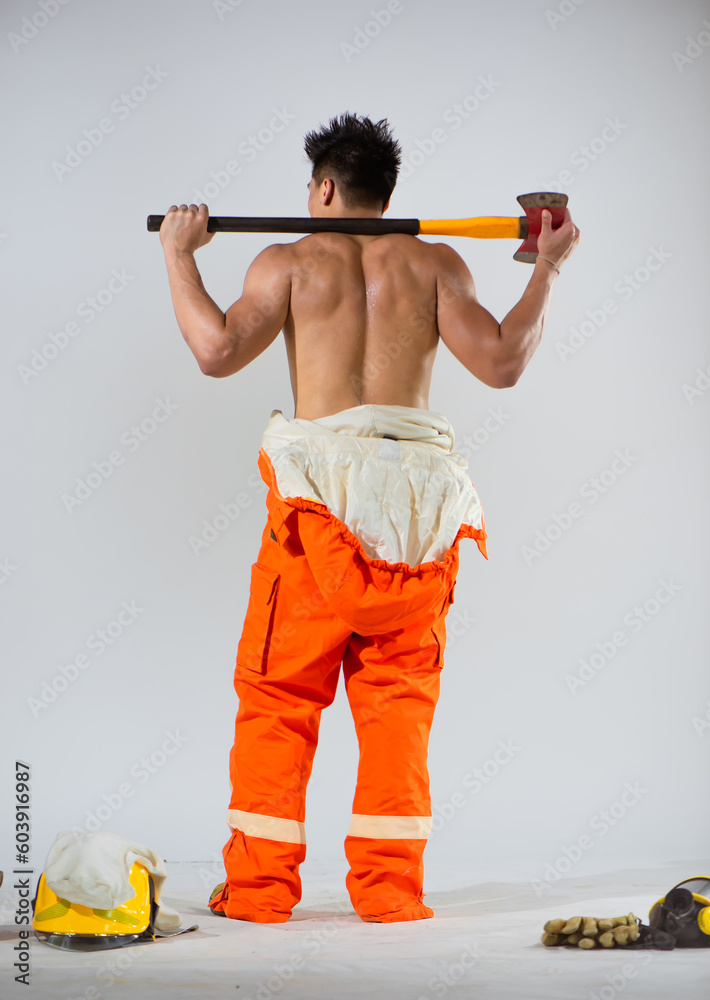 Vertical picture of the professional firefighter is standing with his ...