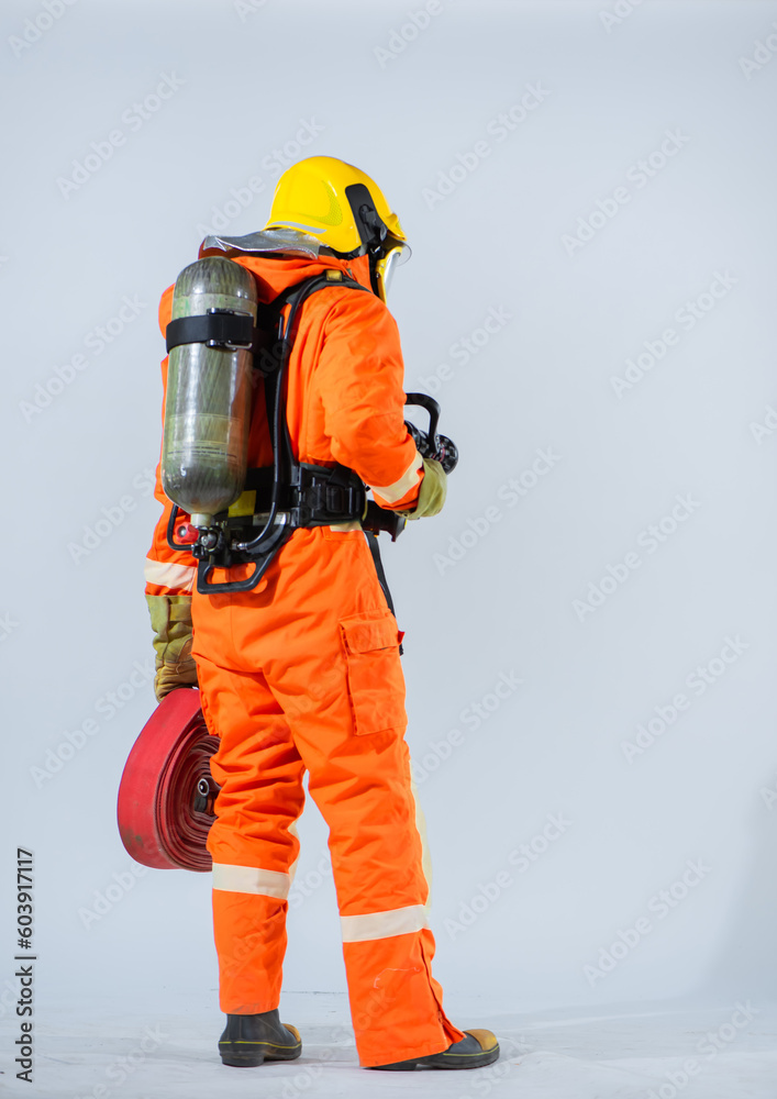 Vertical picture of the professional firefighter is standing with his ...