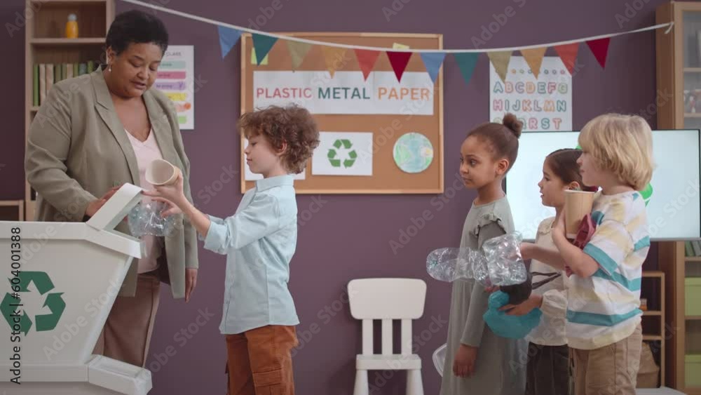 Multicultural primary school kids sorting garbage into recycling ...