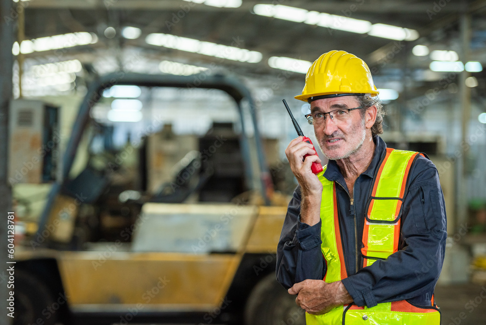 male maintenance engineer in uniform helmet safety talk by walki talkie ...