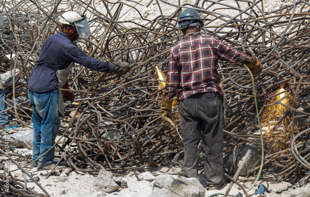 steel reinforcement scrap, welders cutting steel reinforcement scrap in ...