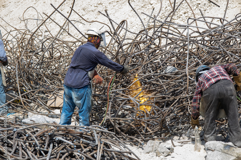 steel reinforcement scrap, welders cutting steel reinforcement scrap in ...