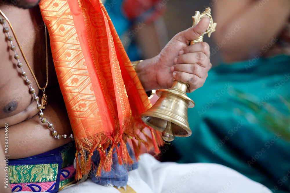 Hand holding ceremonial bell, Sri Srinivasa Perumal Hindu temple, Hindu ...