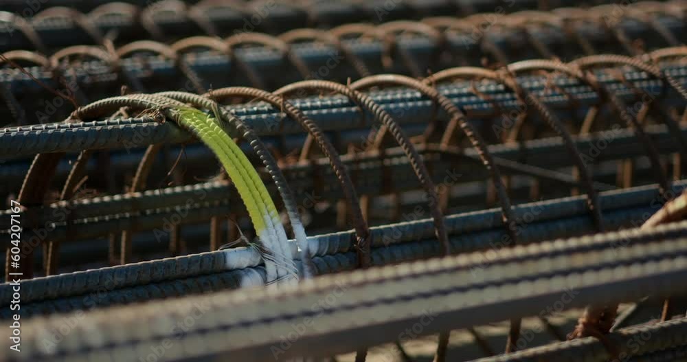 Circular rebar cages are lined up on the ground. They will be used as ...