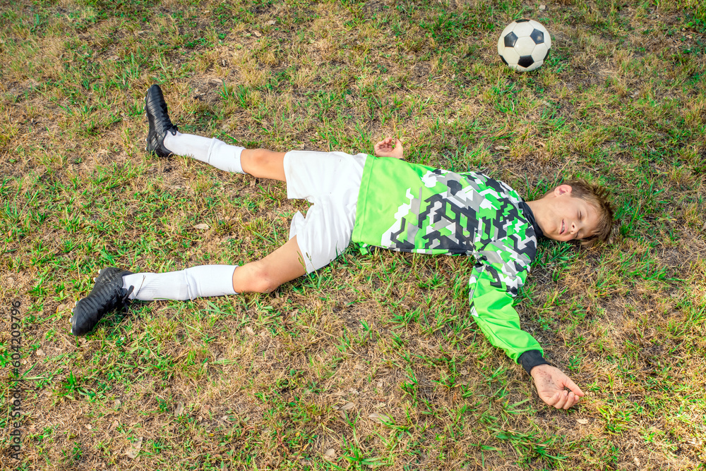 Injured youth soccer player goalie lying unconscious on the field Stock ...