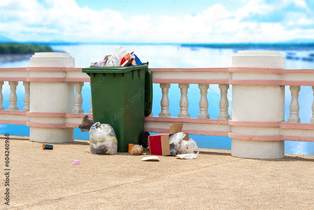 Plastic bin full of garbage on the bridge. Plastic waste, glass bottle ...