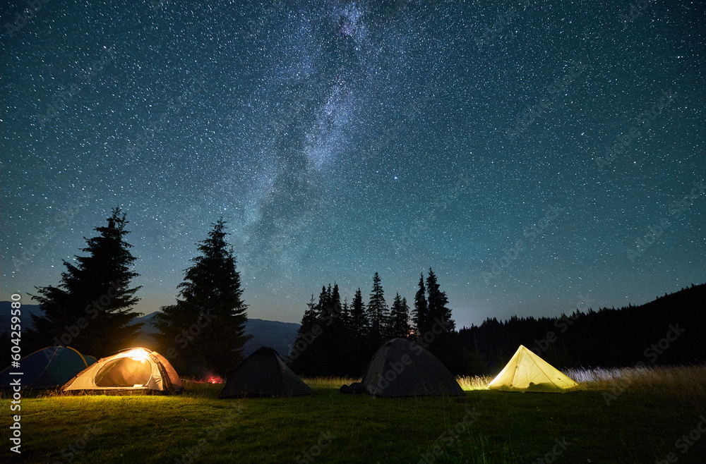 Night camping in mountains under starry sky. Tourist tents in campsite ...