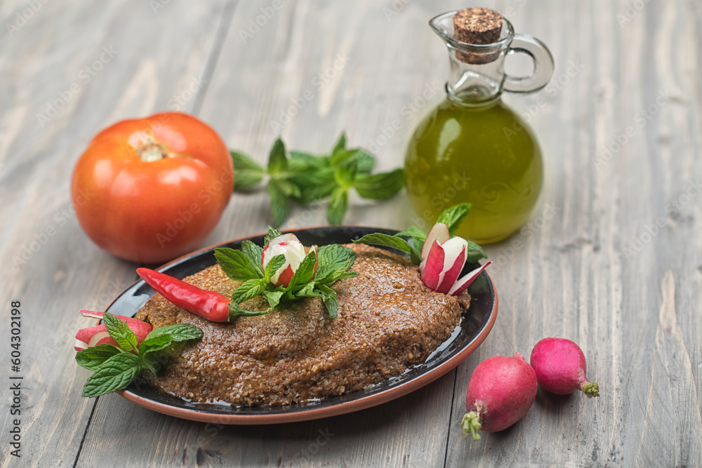 Traditional Lebanese Raw meat kibbeh with olives oil and pita bread and ...