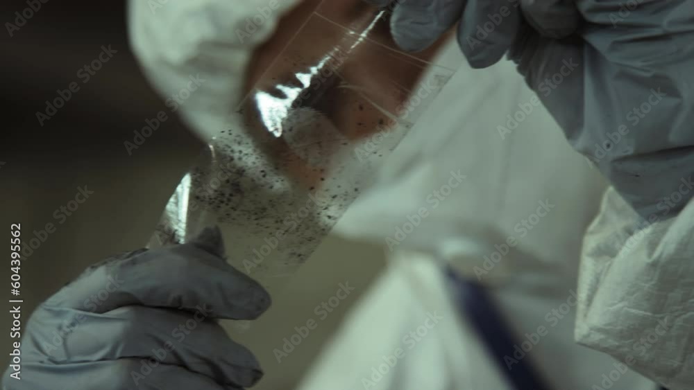 Video „Close-up shot of face and hands of female forensic investigator ...