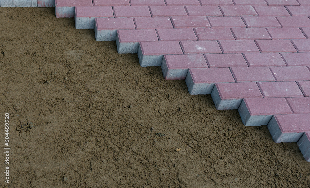 The process of building and repairing a sidewalk paved with brick, a ...