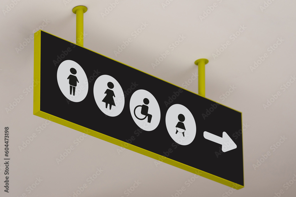 Public toilet sign with symbols and arrow showing direction Stock Photo ...