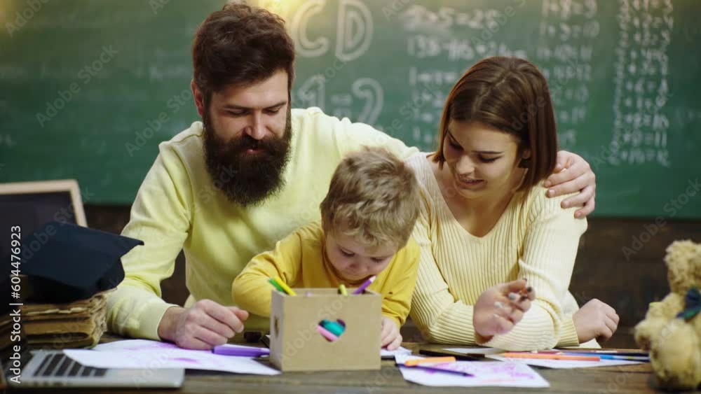 Father and mother teaching children at school. Kids learning and ...
