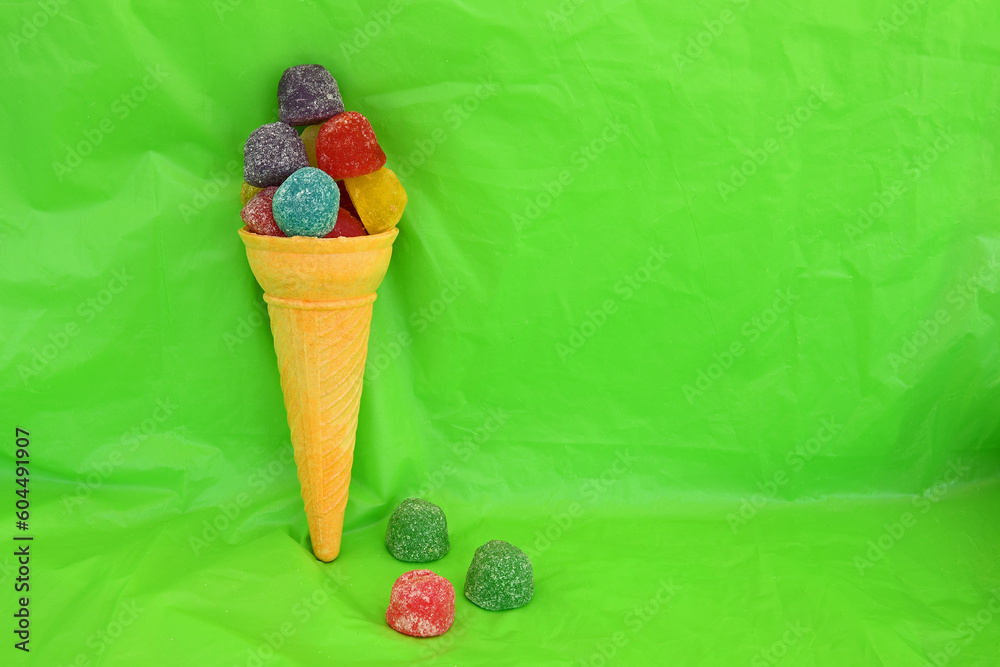 Horizontal side view of colorful medicinal gummies inside of ice cream ...