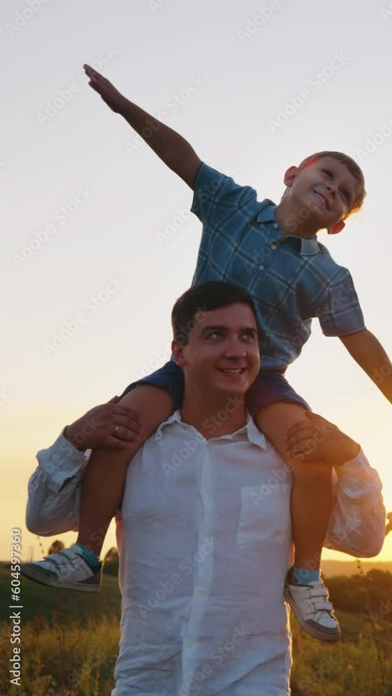 Vertical Screen: Cheerful family spending time together in countryside ...
