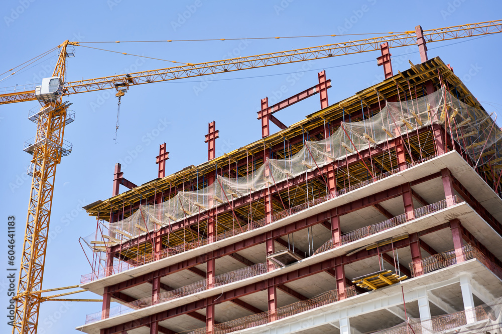 Hydraulic luffing jib tower cranes and workers being poured concrete ...