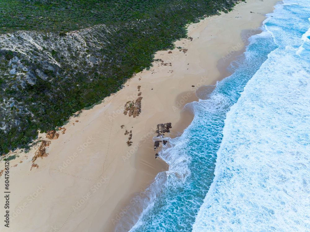 Aerial top down view of beach and clear blue water. Ocean waves on the ...