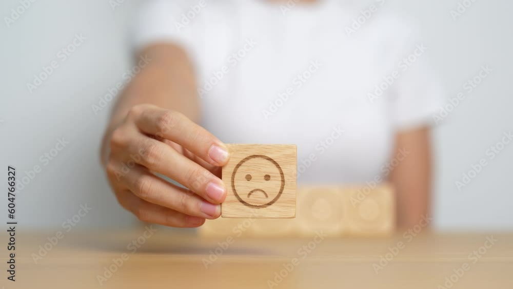 Hand choosing unhappy angry face from Emotion block. customer review ...
