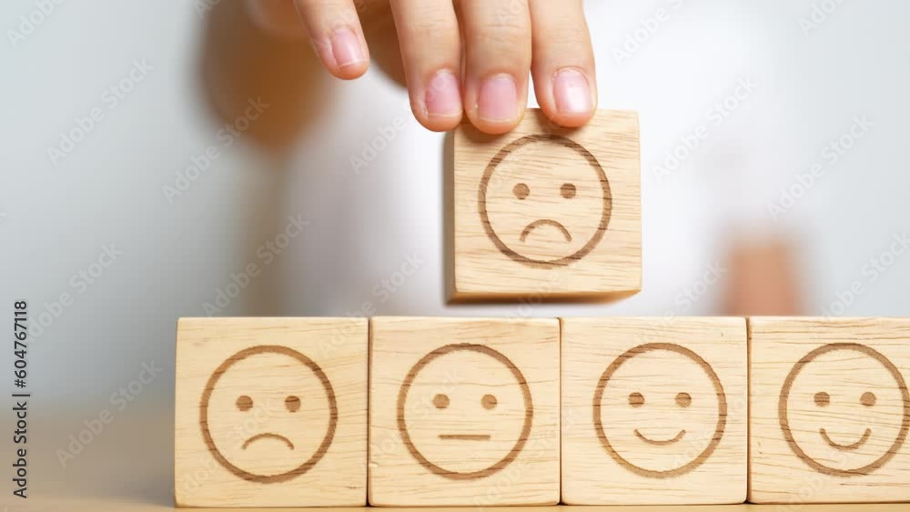 Hand choosing unhappy angry face from Emotion block. customer review ...