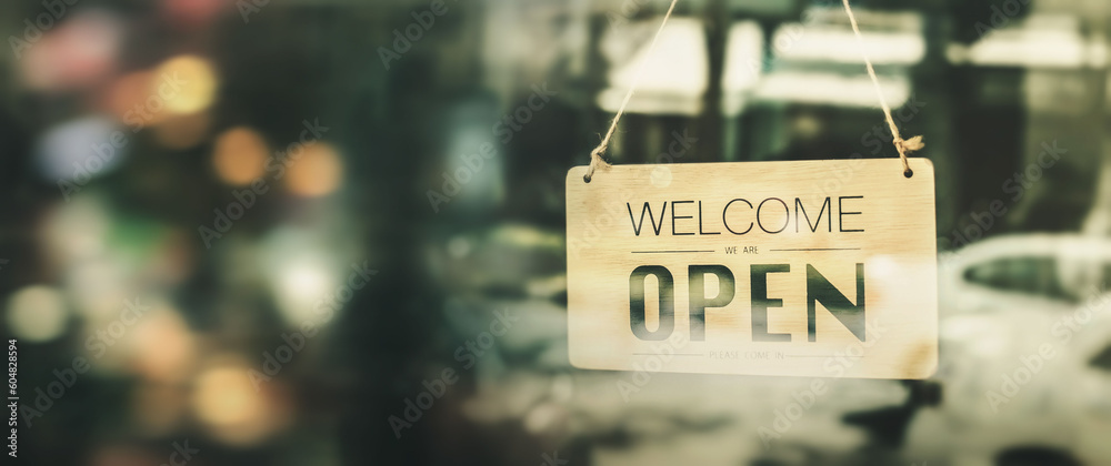 Open sign broad hanging on wood door front of cafe. Welcome. Open. open ...