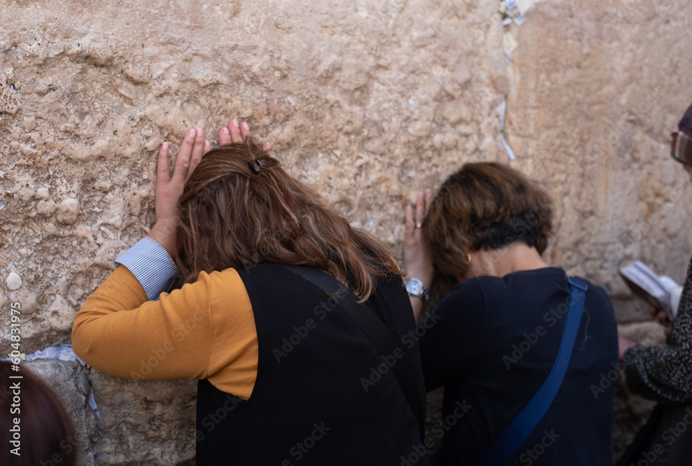 Two religion different races women standing by back and praying on ...