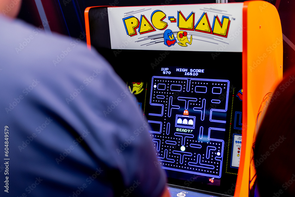 Warsaw, Poland - May 21, 2023: Man playing Pac Man arcade game Stock ...