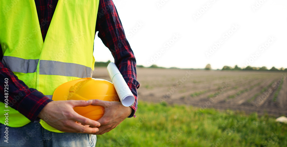 Construction worker holding his yellow helmet, hard hat and ...