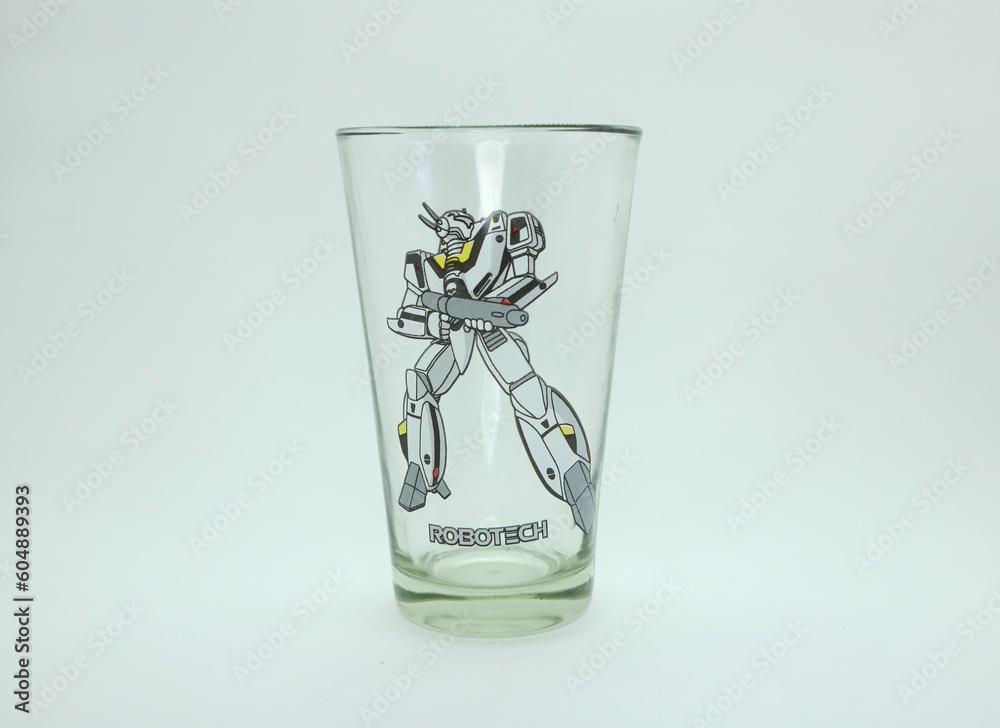 Glass cup with a drawing of a robot from the Robotech television series ...