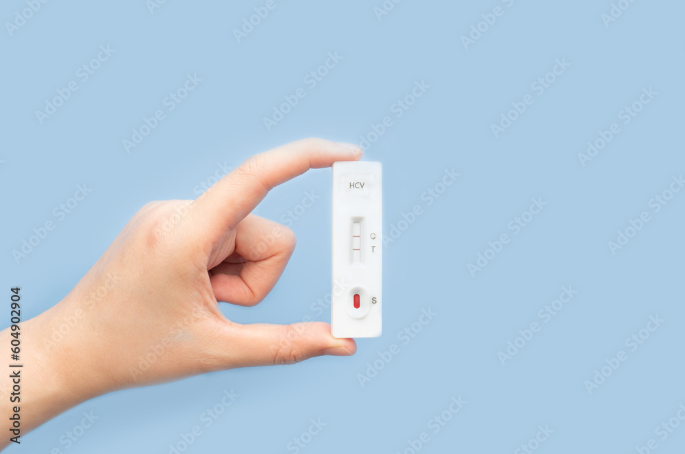 Hand holding hepatitis C virus antibody test kit with positive result ...