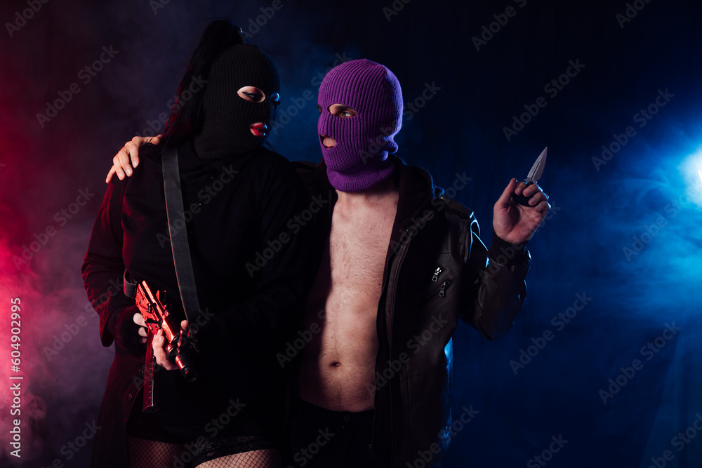 Foto de bandits with a machine gun in a dark room do Stock | Adobe Stock