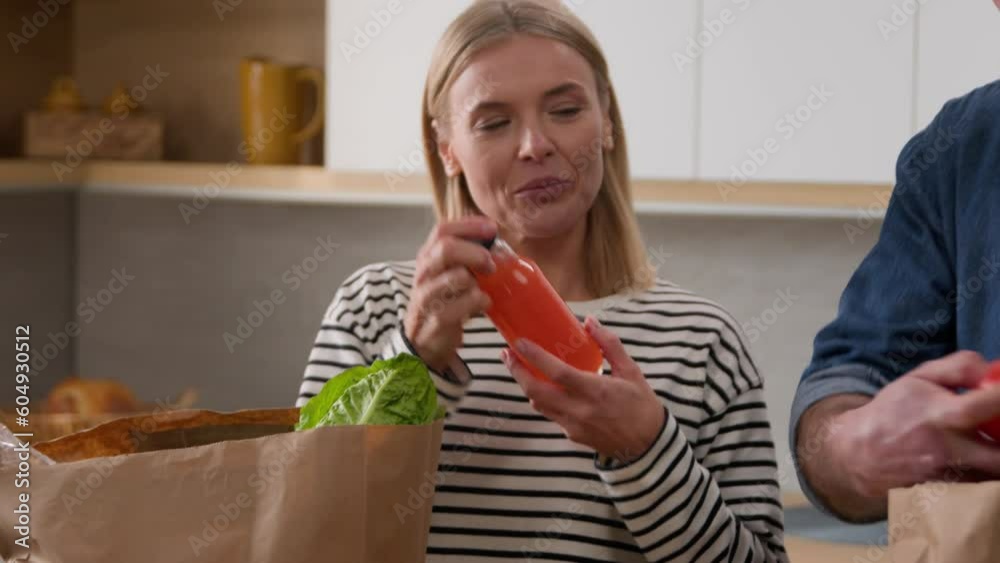 Caucasian adult couple unpack food package shopping delivery bag ...