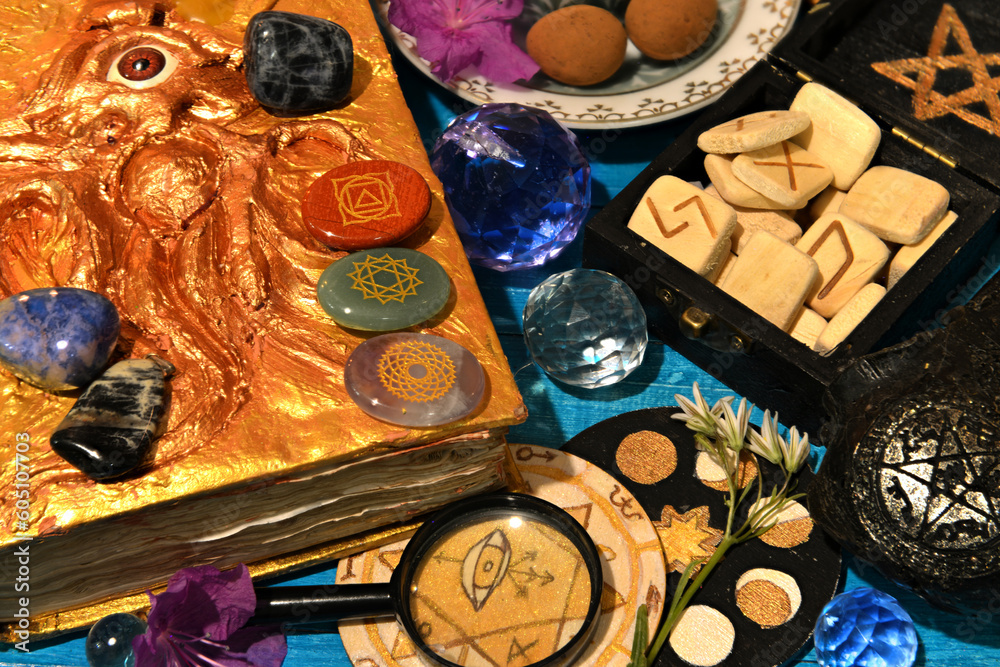 Chakras, runes and magic book of spell on witch altar table. Occult ...