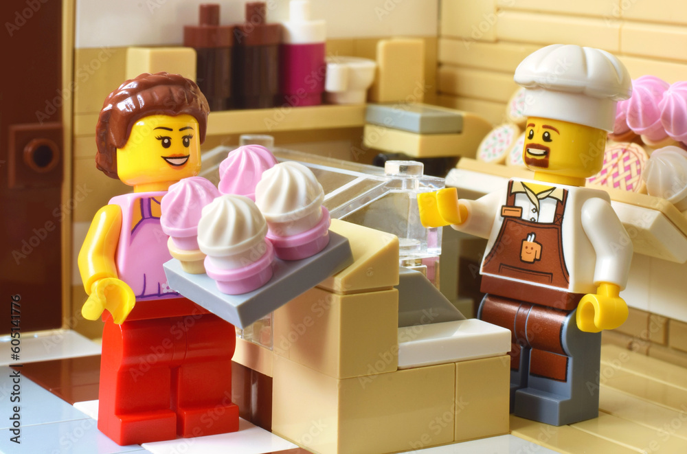 Lego minifigure baker with pastry and cakes and smiling girl in shop ...