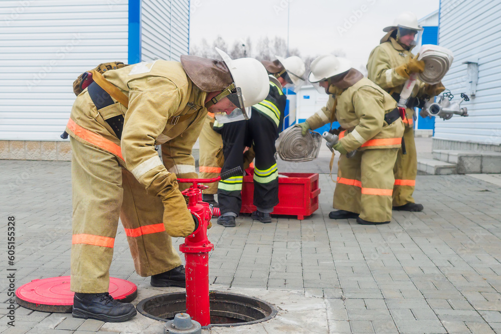 Fire brigade deploys equipment outside in open air and connects fire ...