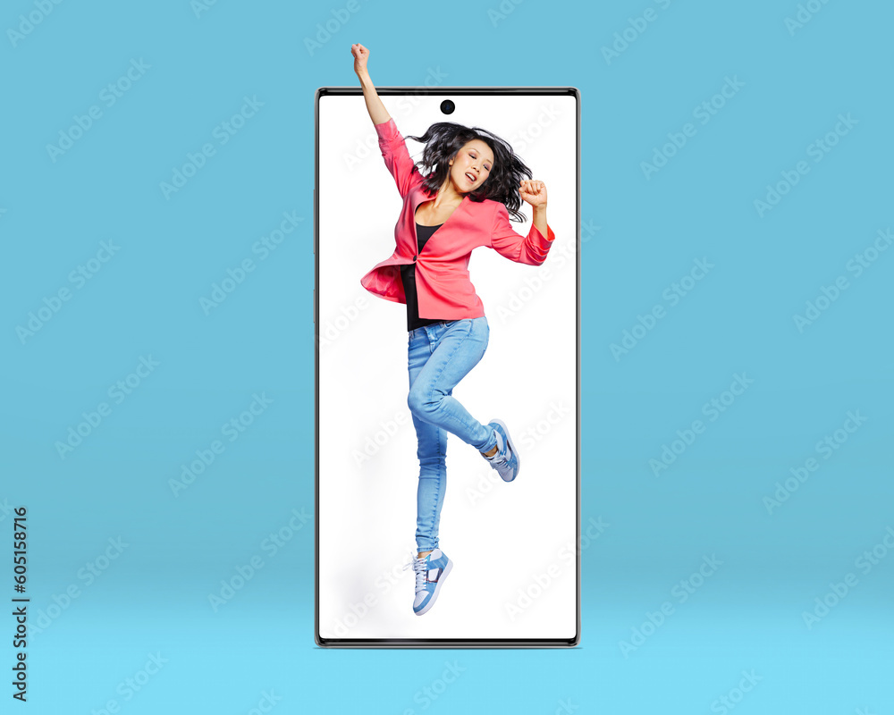 positive young women jumping from the smartphone display in air over ...