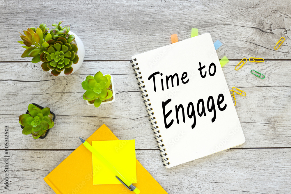 light background. white keyboard and potted plants. Time to Engage text ...