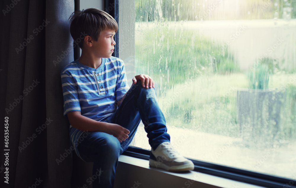 Little boy, home and watching the rain by window of natural water drops ...
