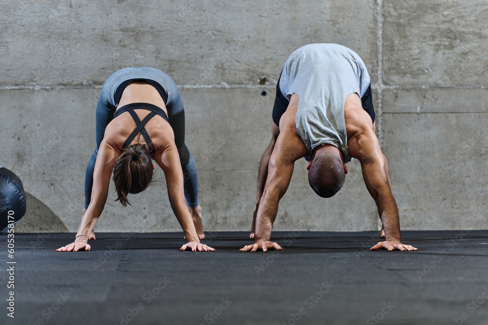 An attractive couple in the gym engaging in various stretching ...