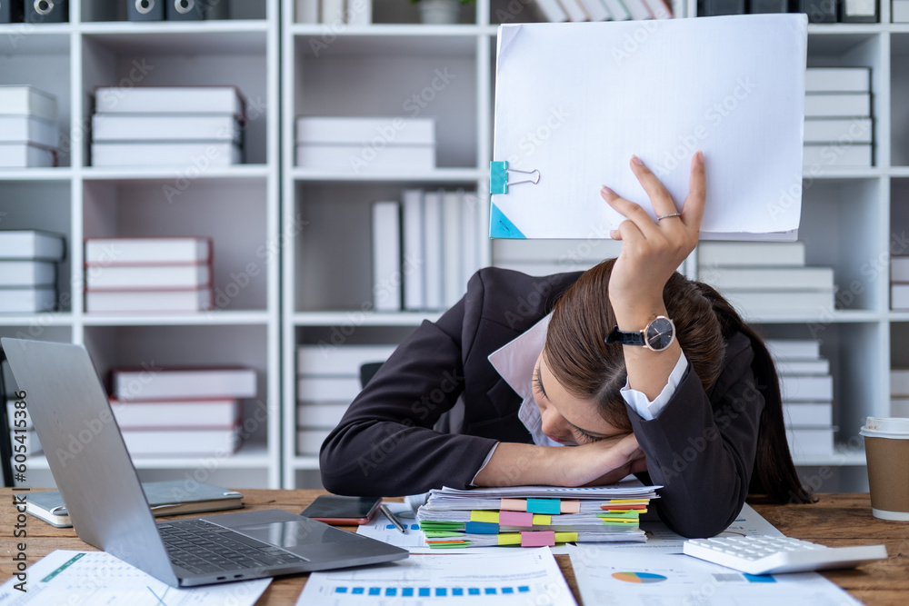 Overworked and tired businesswoman sleeping over document in office ...