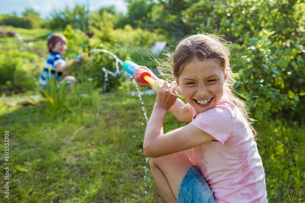 Two little kids playing with water guns on hot summer day. Cute ...