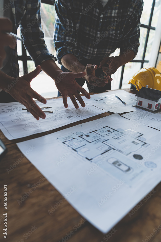 Team of engineers, architects meeting plans on blue print house plan ...