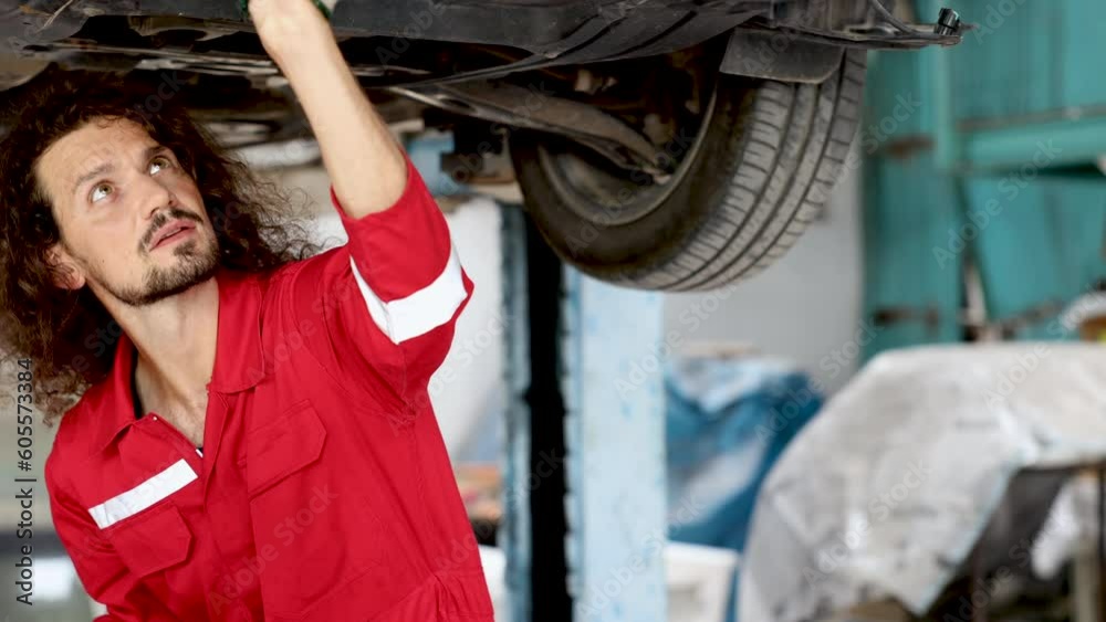 Caucasian Smart man checking car maintenance SUV suspension of a lifted ...