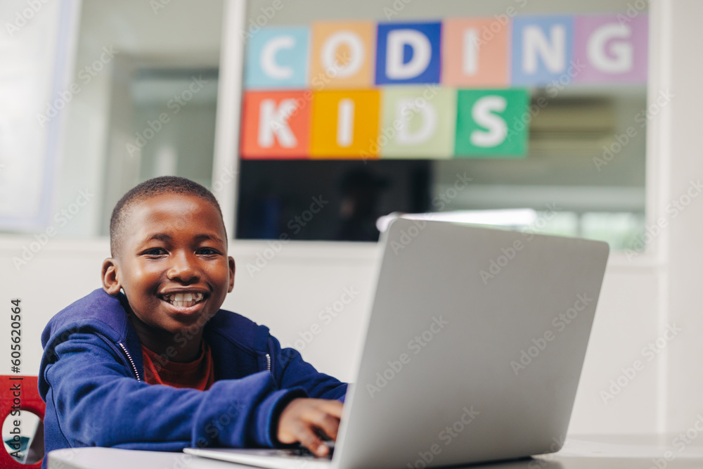 Young black student learning to code in a computer-based learning ...